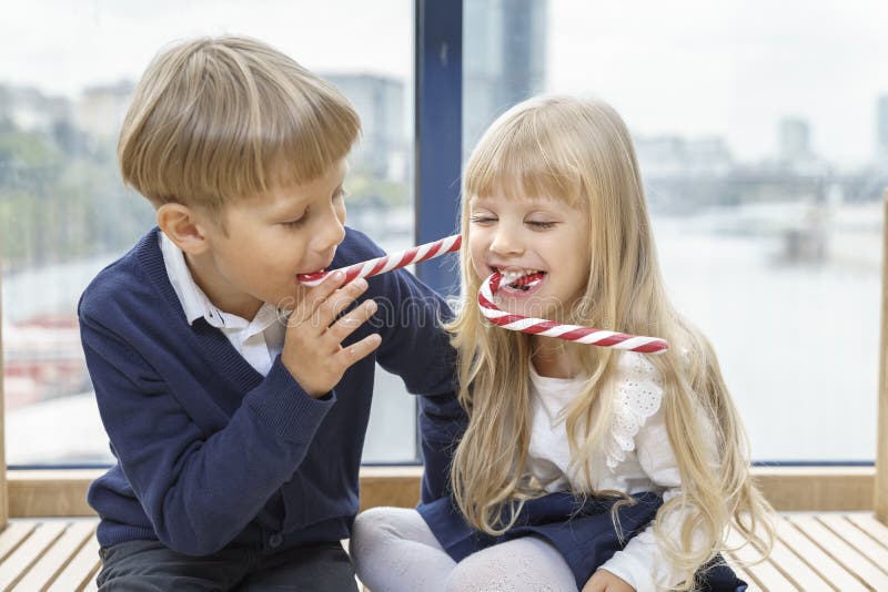 A Child with Contentment Eats a Candy Cane Stock Image - Image of ...