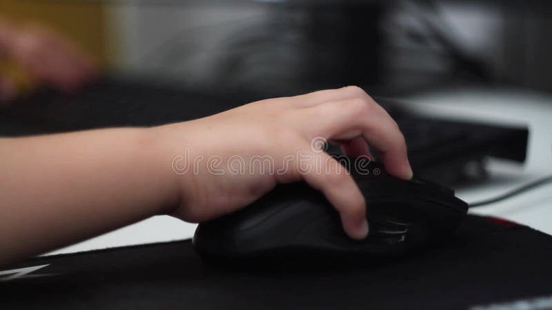 The Child Controls the Computer Mouse. the Boy at the Computer ...