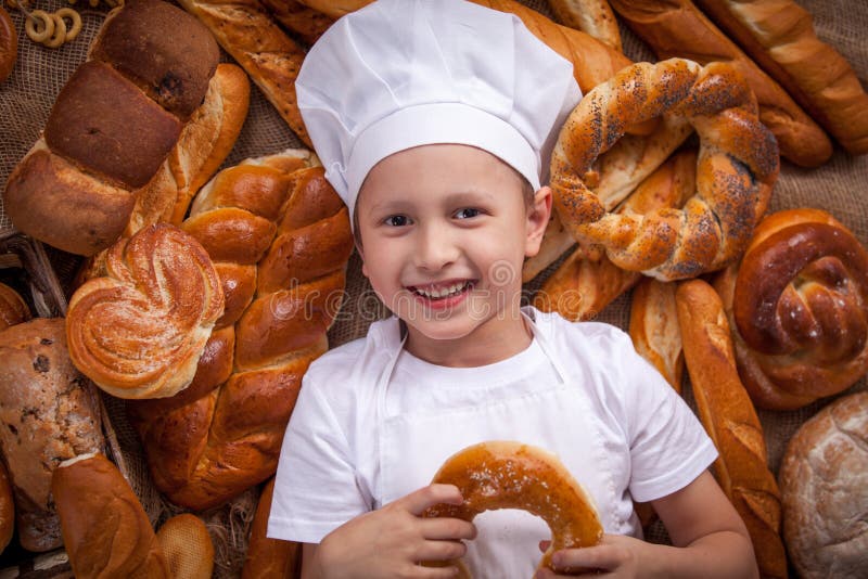 Child Cook Dressed Up Lies Baker a Lot of Bread Rolls Stock Image ...