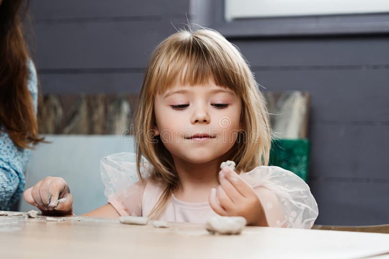 Child Crafting with Modeling Clay Indoors during a Creative Session ...