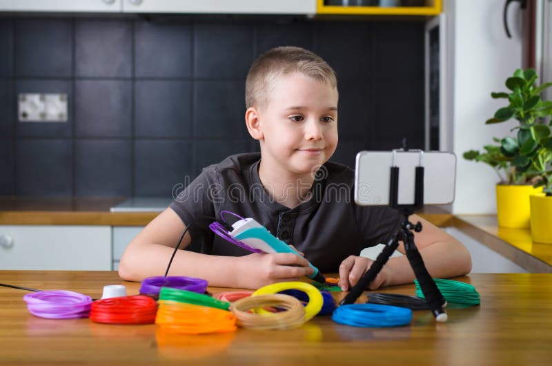 Child Creating with 3d Printing Pen. Happy Boy Does Something with ...