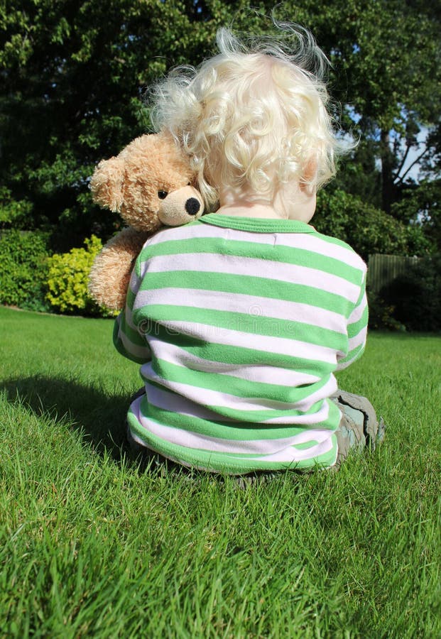 Child cuddling teddy bear stock image. Image of embrace - 16188541