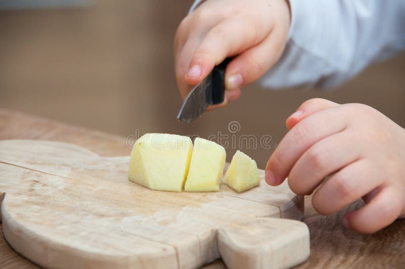 Child cutting an apple stock image. Image of preparing - 238600053