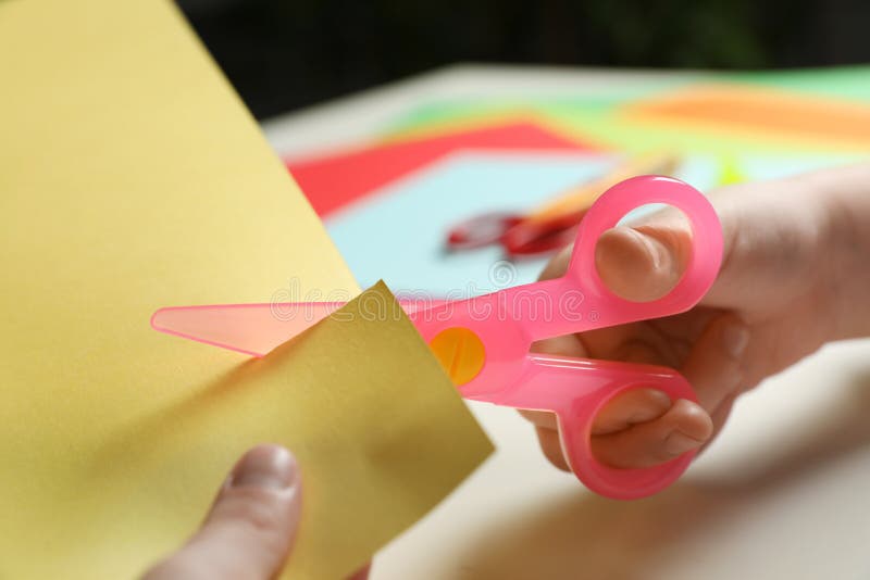 Child Cutting Color Paper with Plastic Scissors at Table Stock Image ...