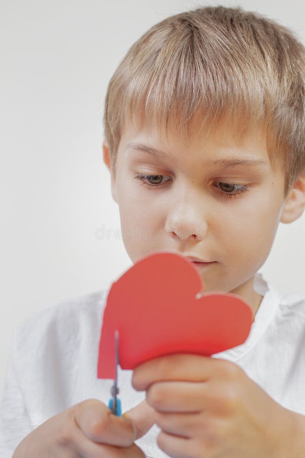 Child Cutting Red Paper Heart with Scissors Stock Photo - Image of ...