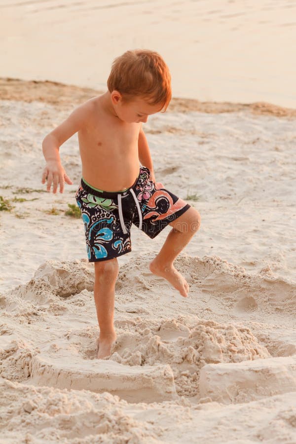 Child destroy sand castle. stock image. Image of leisure - 97470183