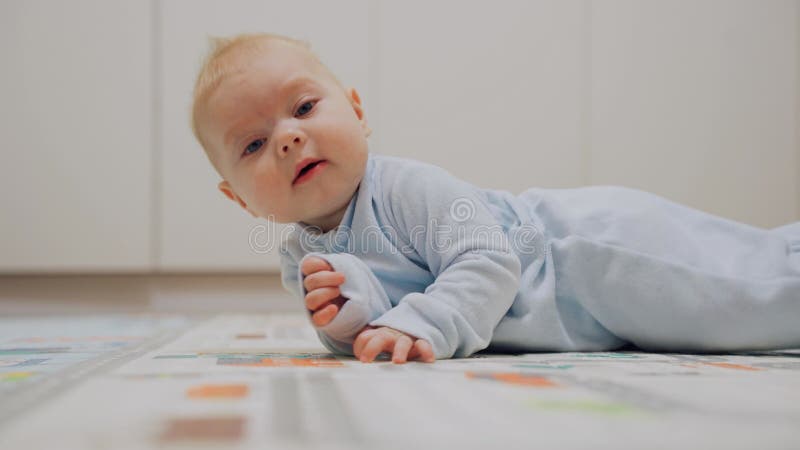 Child Development, Turning Over before Crawling. the Baby Boy is Lying ...