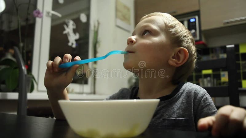 The Child is Distracted while Eating To the TV Stock Video - Video of ...