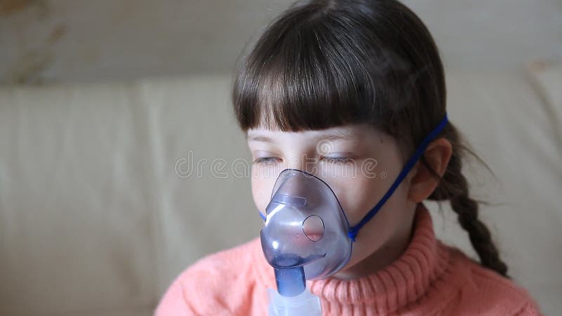 A Child Does Inhalations with a Nebulizer. Cold Treatment Stock Video ...
