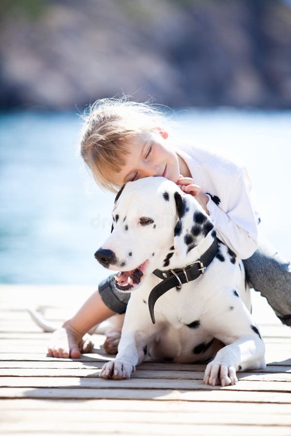 Child with dog stock photo. Image of sitting, dalmatian - 24378814