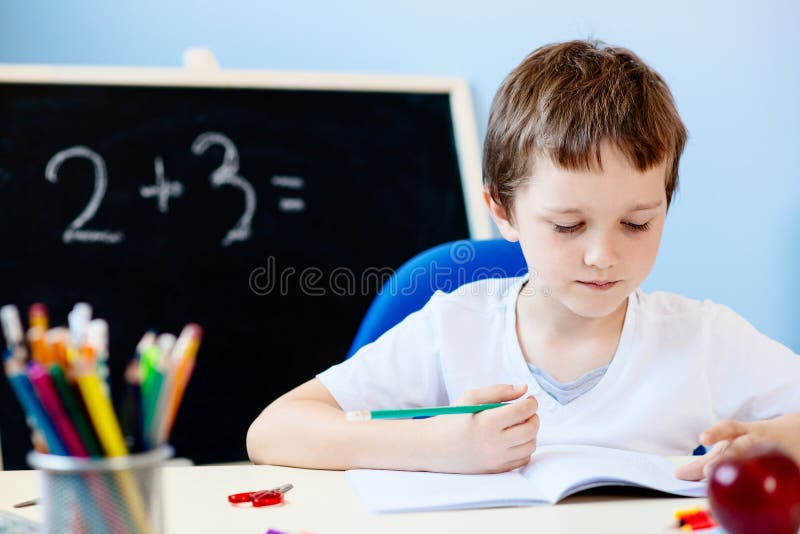 Child doing his homework stock image. Image of reading - 75991195