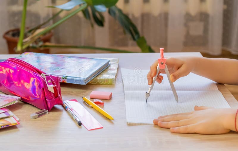 The Child is Doing Homework, Drawing with a Compass. Selective Focus ...