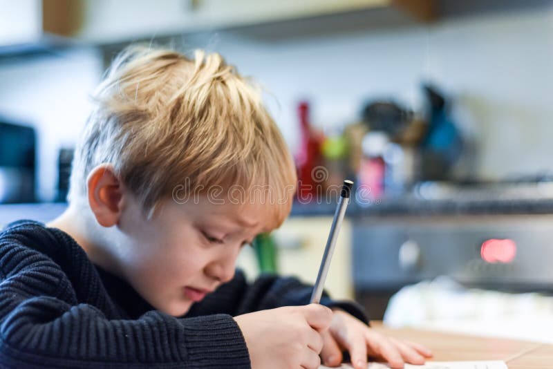 Child Doing Homework at the Kitchen Table at Home during Lockdown Stock ...
