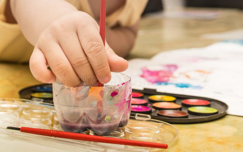 Child drawing with brush stock photo. Image of hand - 171991654