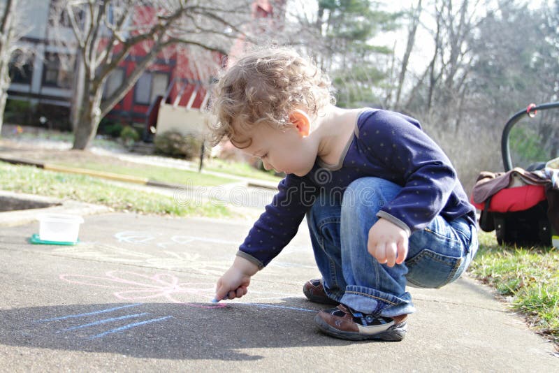 Child Drawing with Chalk Outside Stock Photo - Image of drawing ...