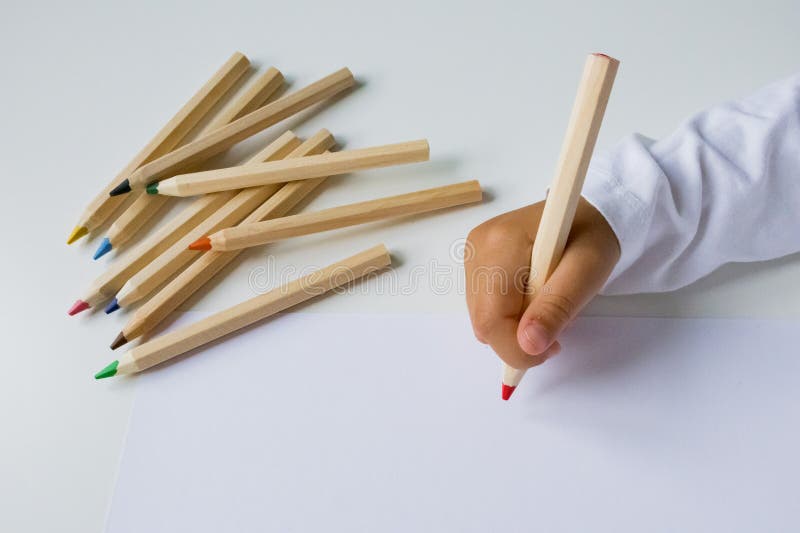 Child Drawing with Colored Pencils on White Paper Stock Image - Image ...