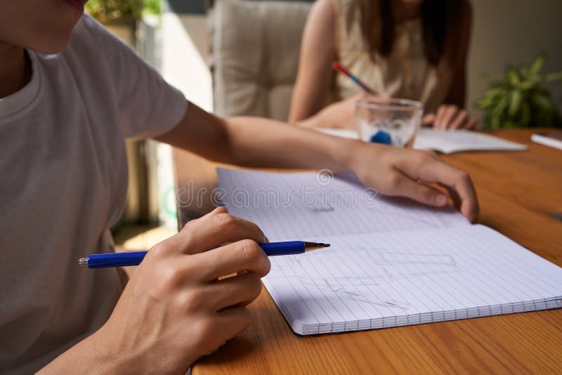 Child Drawing into an Exercise Book, Doing Homework Stock Photo - Image ...