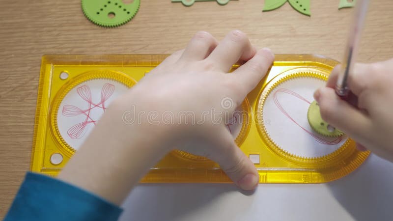 Child Draws with Ballpoint Pen Patterns Using the Graphical Ruler Stock ...