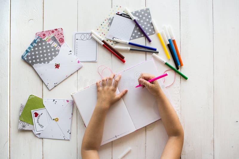 Child draws in a notebook stock image. Image of paper - 75060581
