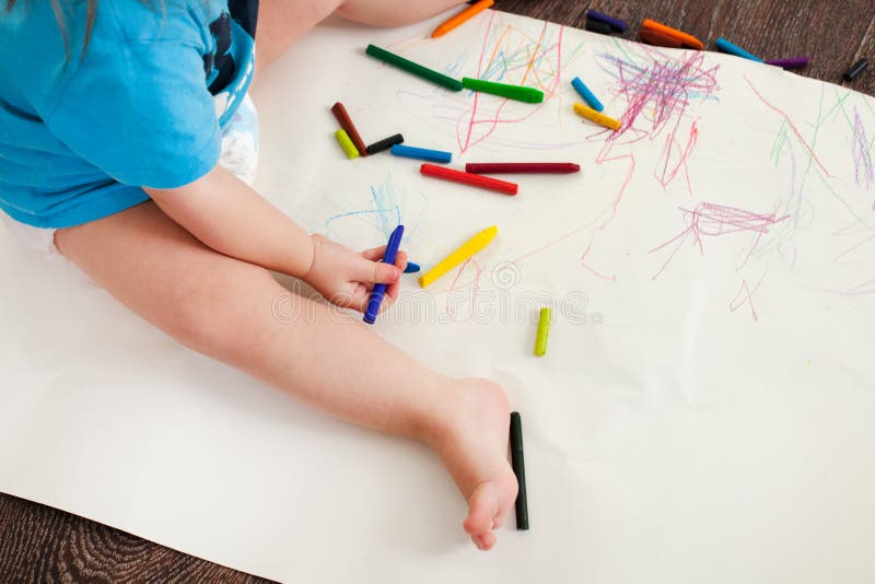 The Child Learns To Draw Wax Crayons, Sits on the Floor Stock Photo ...