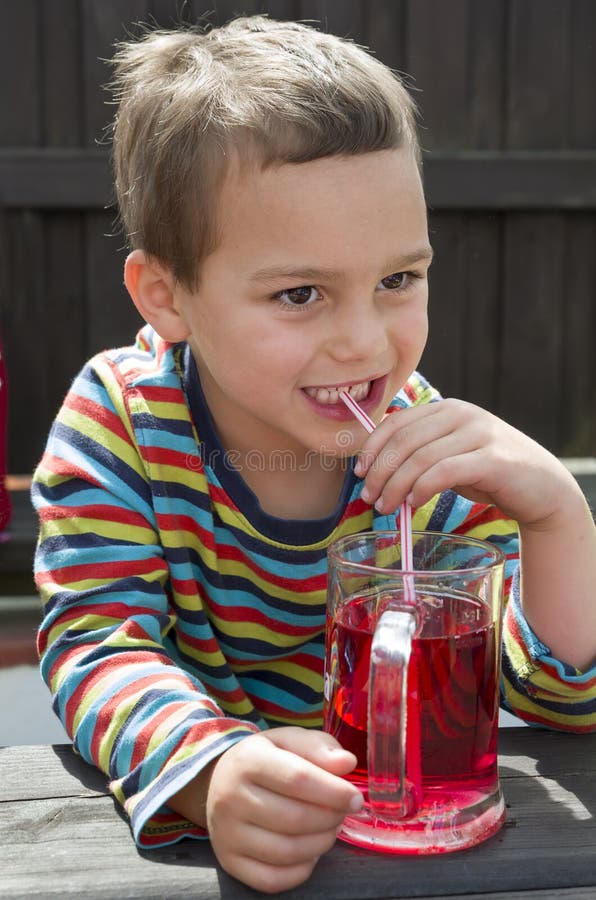 Child drinking lemonade stock photo. Image of garden - 54981874