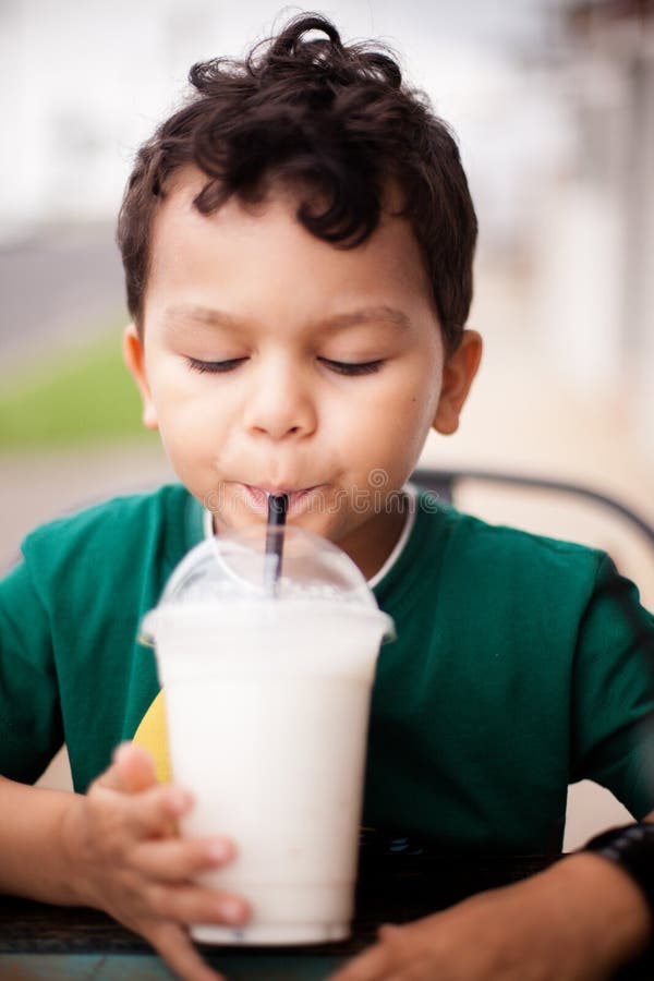 Child Drinking through a Straw Stock Image - Image of dairy, calcium ...