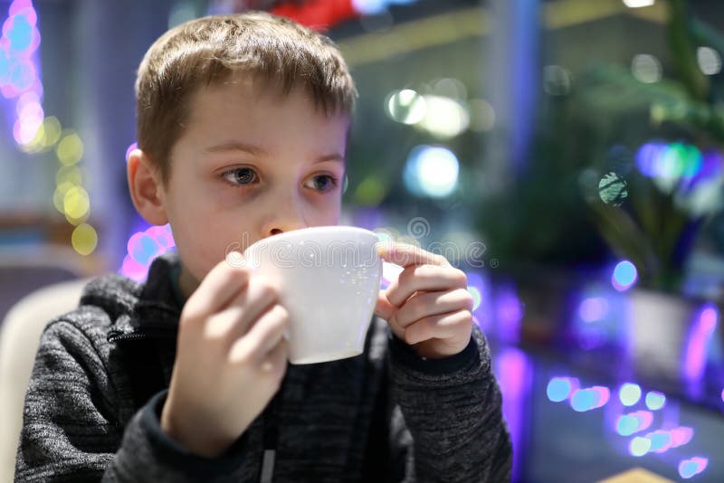 Child drinking tea in cafe stock image. Image of heat - 242927107