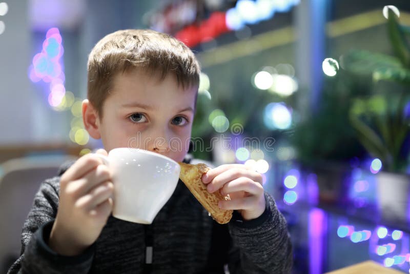 Child Drinking Tea with Eclair in Cafe Stock Photo - Image of cute ...