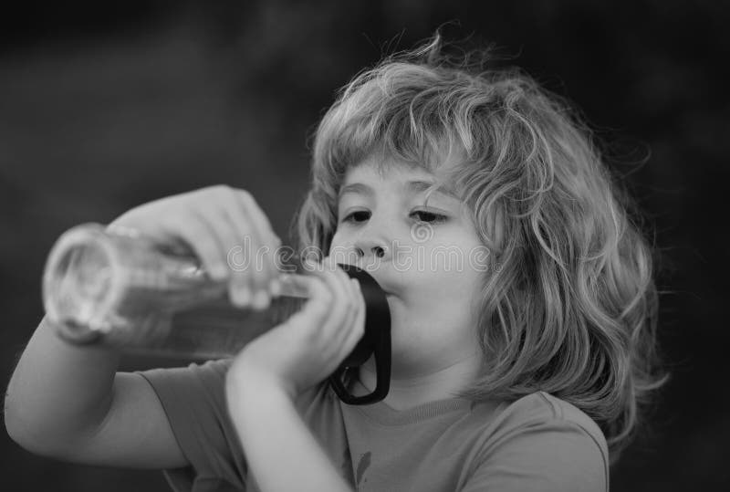 Child Drinking Water from Bottle Outdoor in Park. Kid Drinking. Stock ...