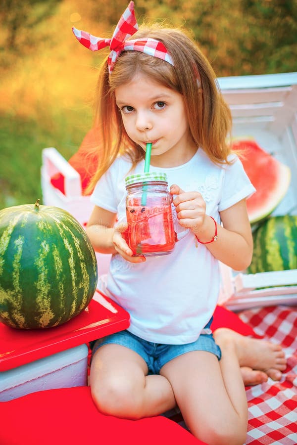 Child Drinking Watermelon Lemonade in Jar with Ice and Mint As Summer ...