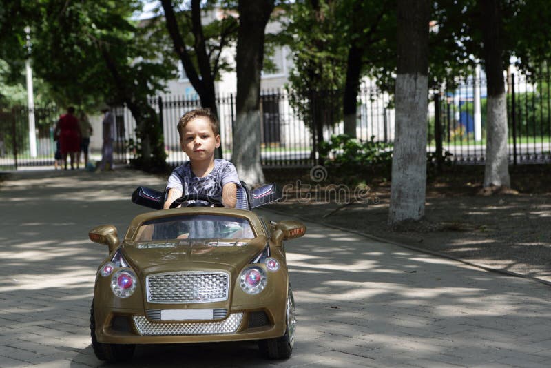 Child driving a toy car stock image. Image of childhood - 58300823