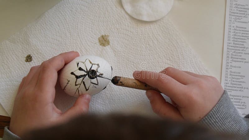 A Child Dying Easter Egg with with Wax and Dye Method Stock Footage ...
