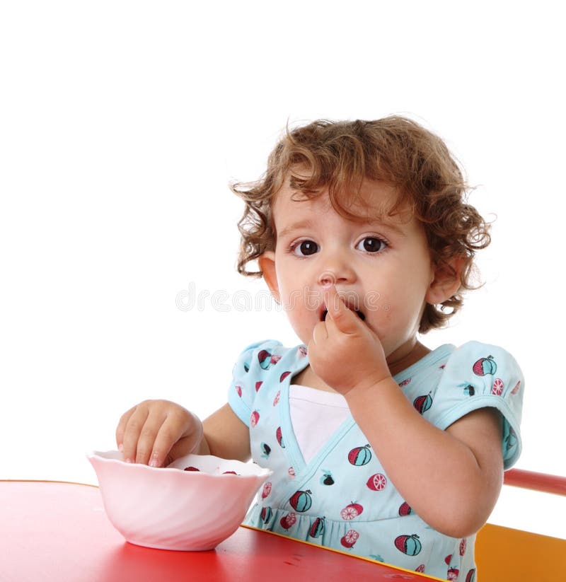 Cute Baby Girl Eating Yogurt from Spoon Stock Photo - Image of chair ...