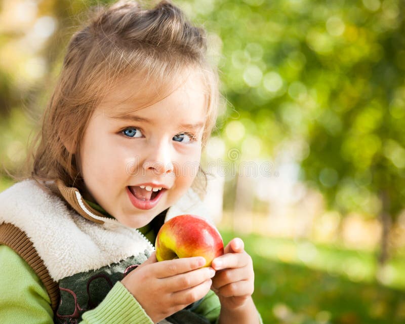Child eating apple stock image. Image of green, face - 25070213