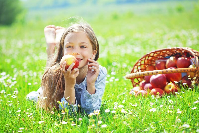 Child Eating Apple in a Field Stock Photo - Image of joyful, childhood ...
