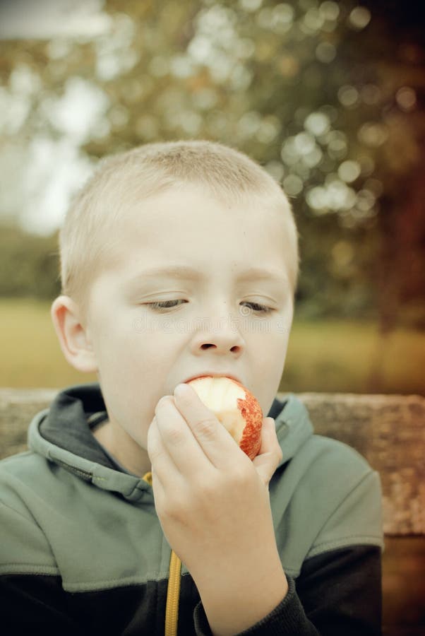 Child eating apple stock photo. Image of park, outdoor - 46266218