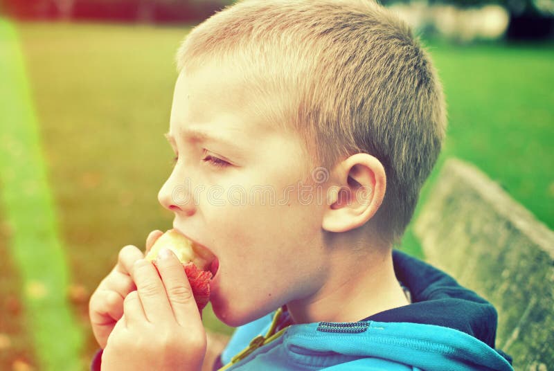 Child eating apple stock image. Image of outdoor, caucasian - 46991901