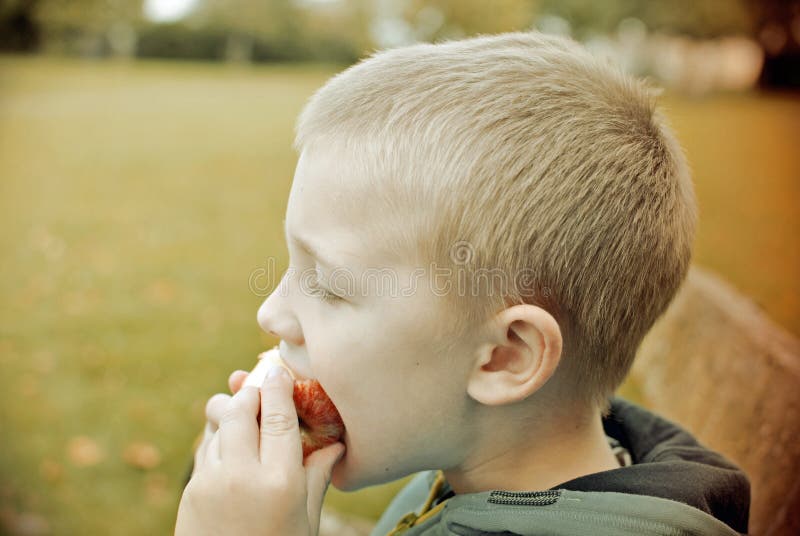 Child eating apple stock image. Image of blonde, apple - 46991921