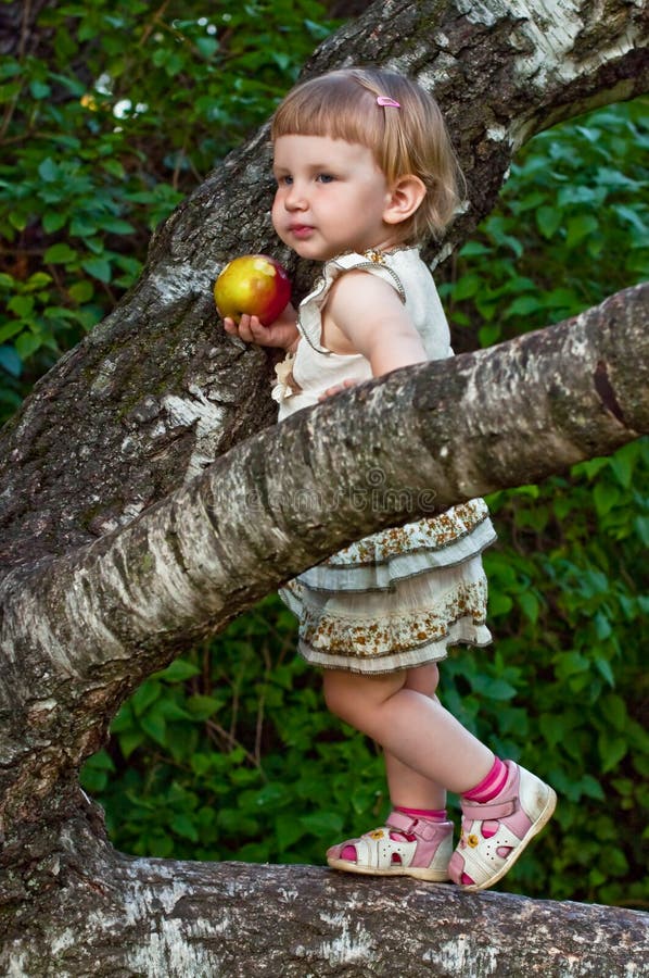 Child Eating Apple in the Tree Branches Stock Photo - Image of ...