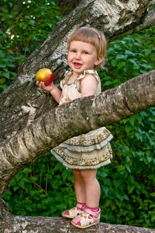 Child Eating Apple in the Tree Branches Stock Photo - Image of standing ...