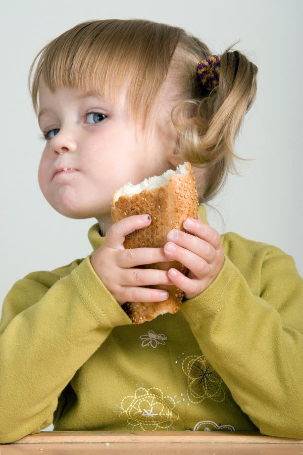 Child eating bread stock photo. Image of divide, casual - 1370878