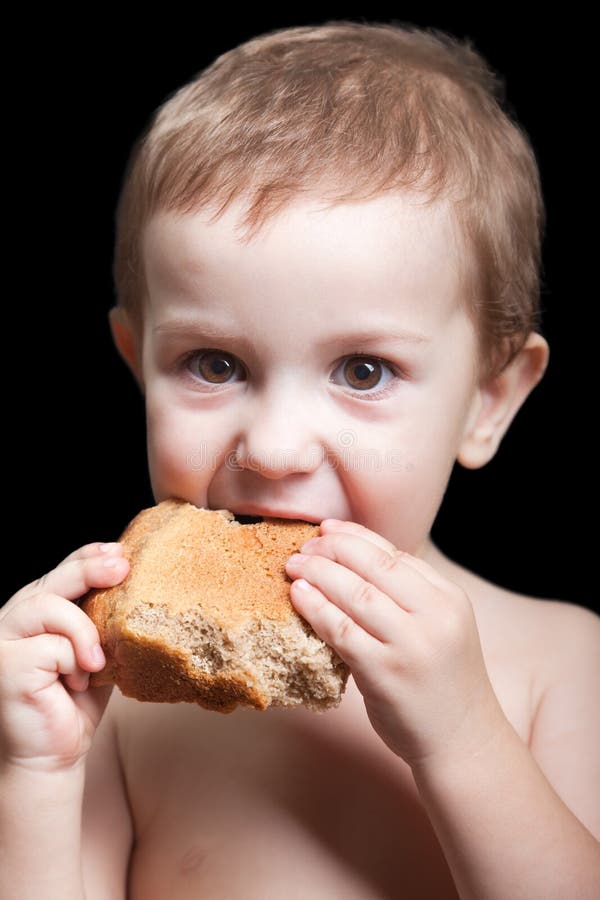 Child eating bread stock photo. Image of charity, hand - 16776328