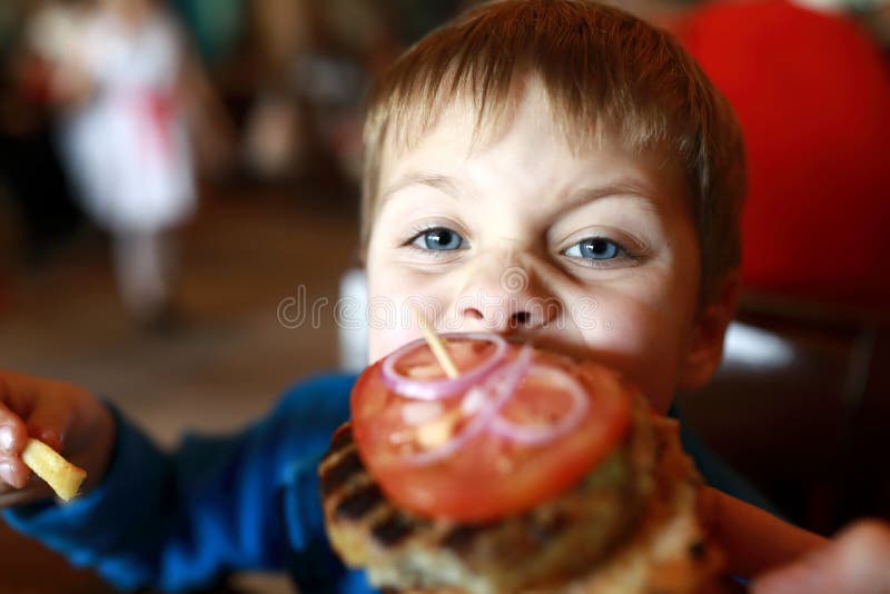 Child eating burger stock photo. Image of burger, appetizing - 162608904