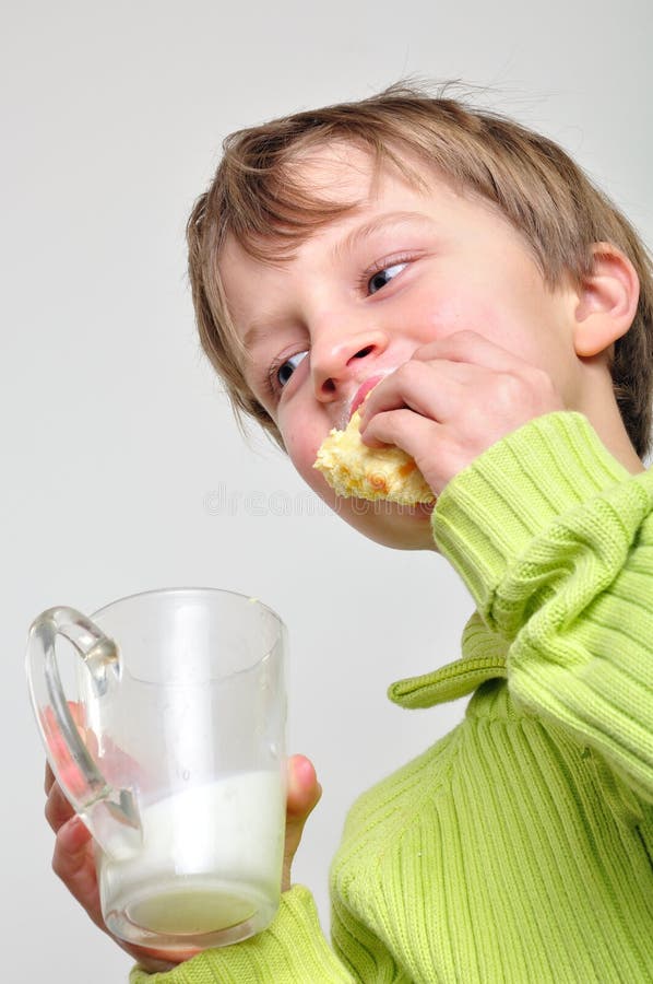 Child Eating Cake and Drinking Milk Stock Image - Image of eating ...