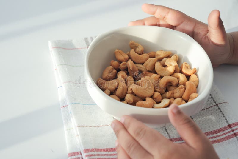 Child Eating Cashew Nuts on Table Stock Photo - Image of organic, tasty ...