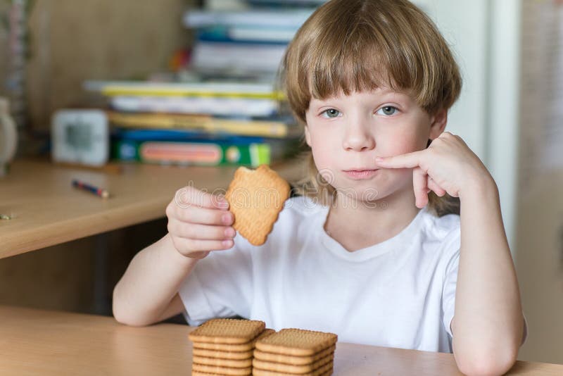 Child eating cookies stock photo. Image of shoulders - 80373148
