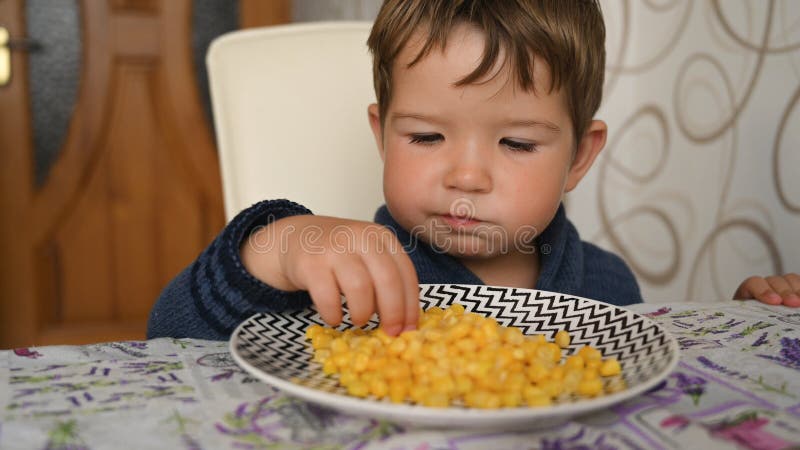 Child Eating Corn from a Plate Stock Image - Image of cute, dinner ...