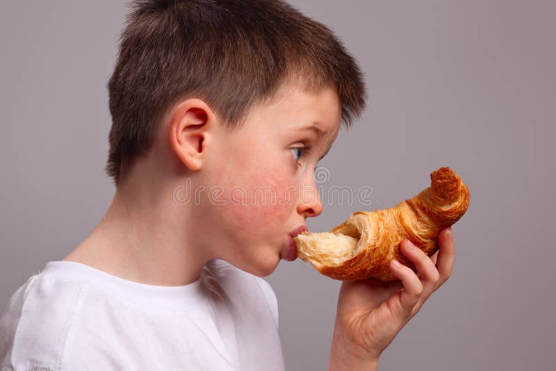 Child eating a croissant stock image. Image of head, boys - 8486511
