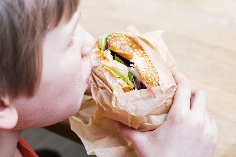Child eating hamburger stock image. Image of tasty, closeup - 178171903