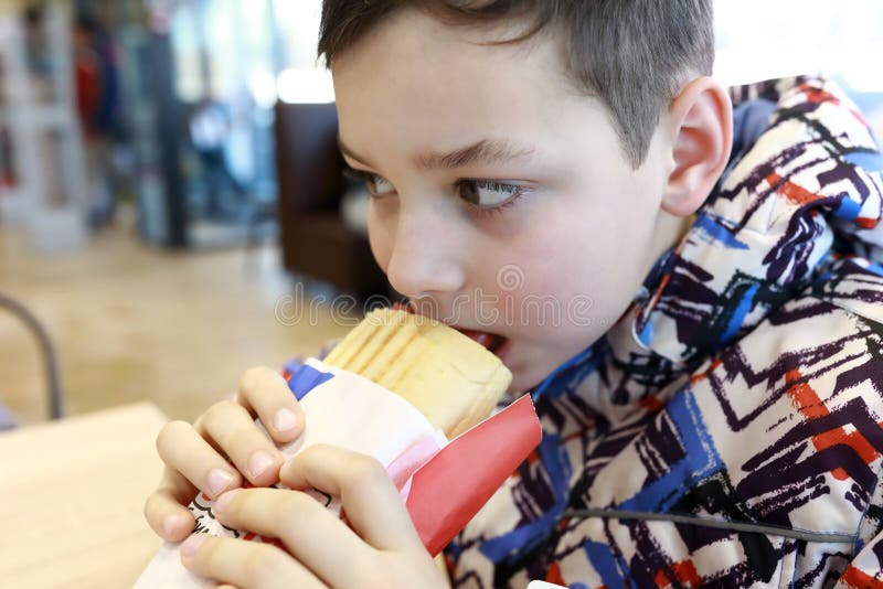 Child eating hot dog stock image. Image of caucasian - 242927113